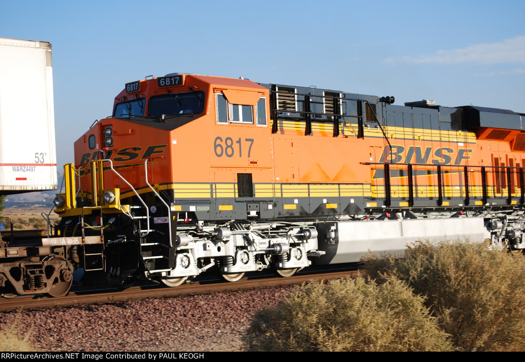BNSF 6817 with the Rising Sun Glistens as she heads east.